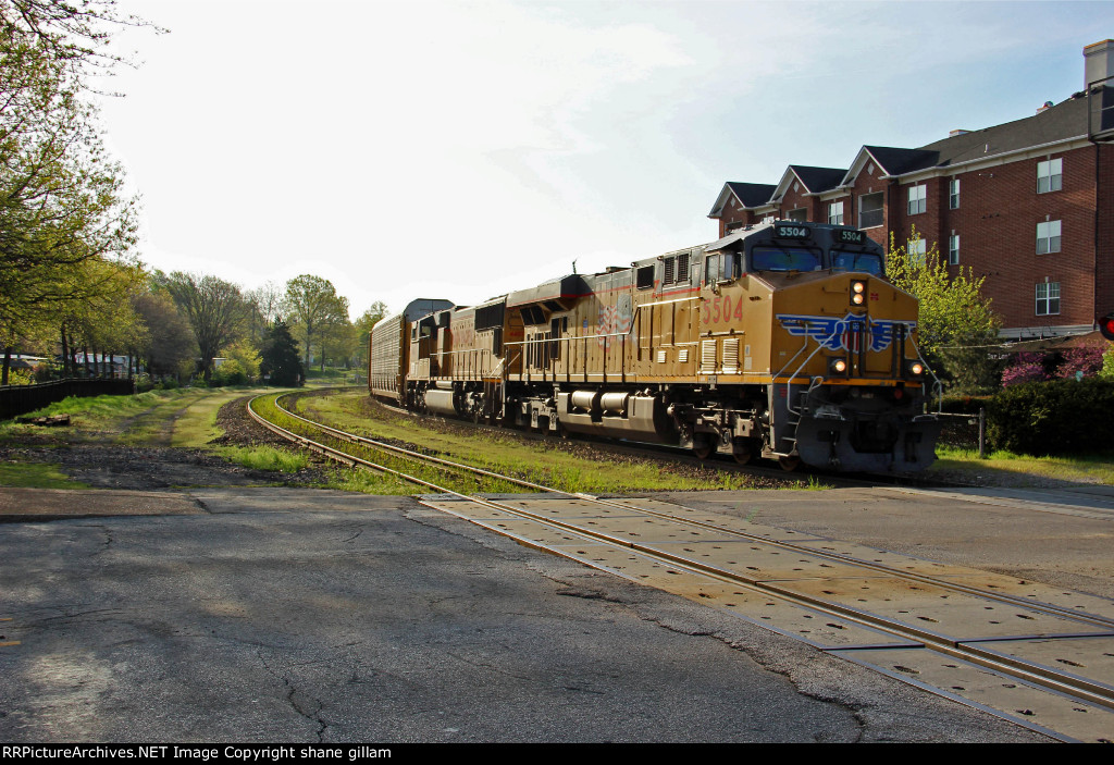 UP 5504 Heads Wb with a auto rack train.